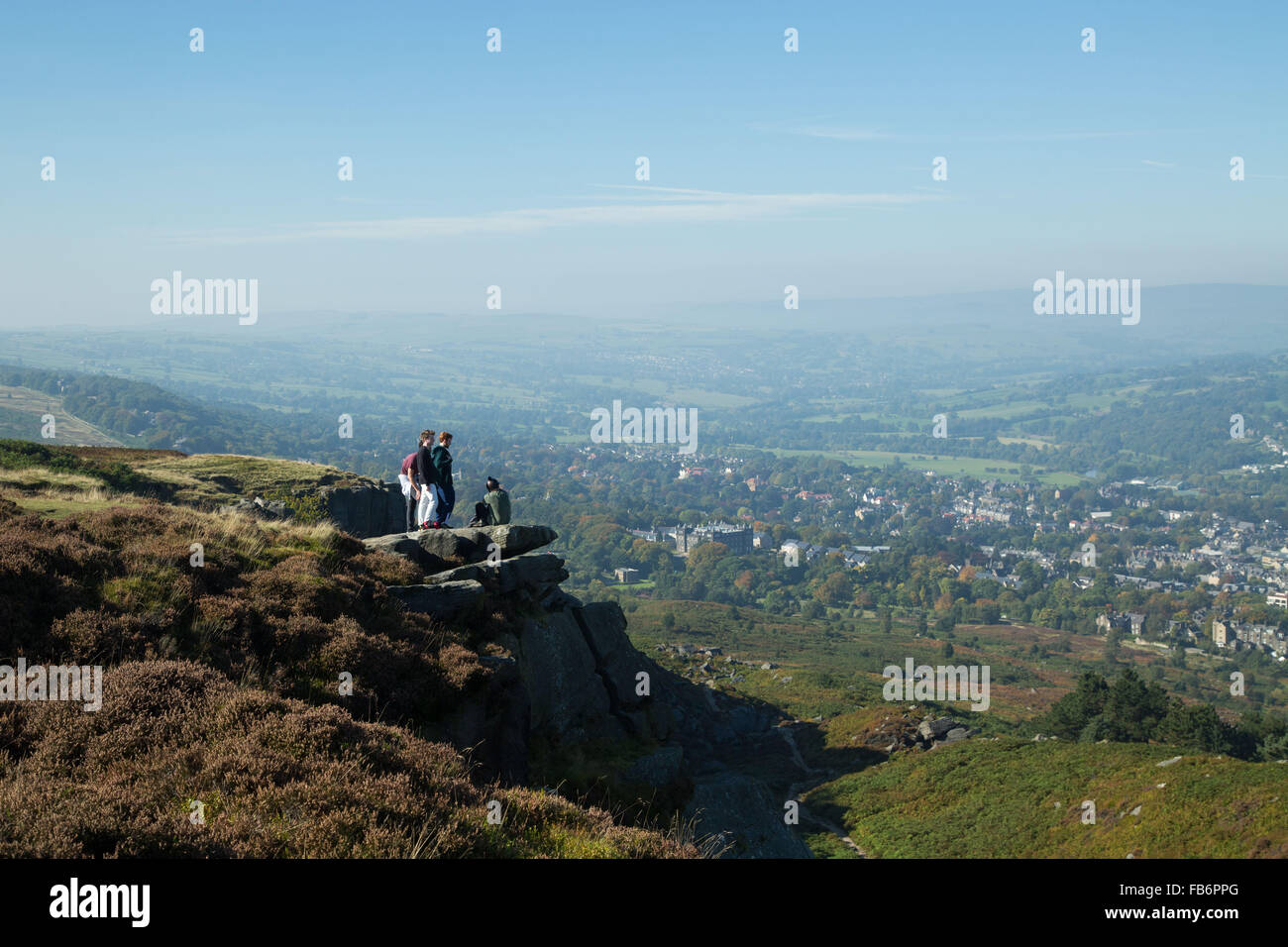 A group of people look over the amazing view of Ilkley from the top of ...