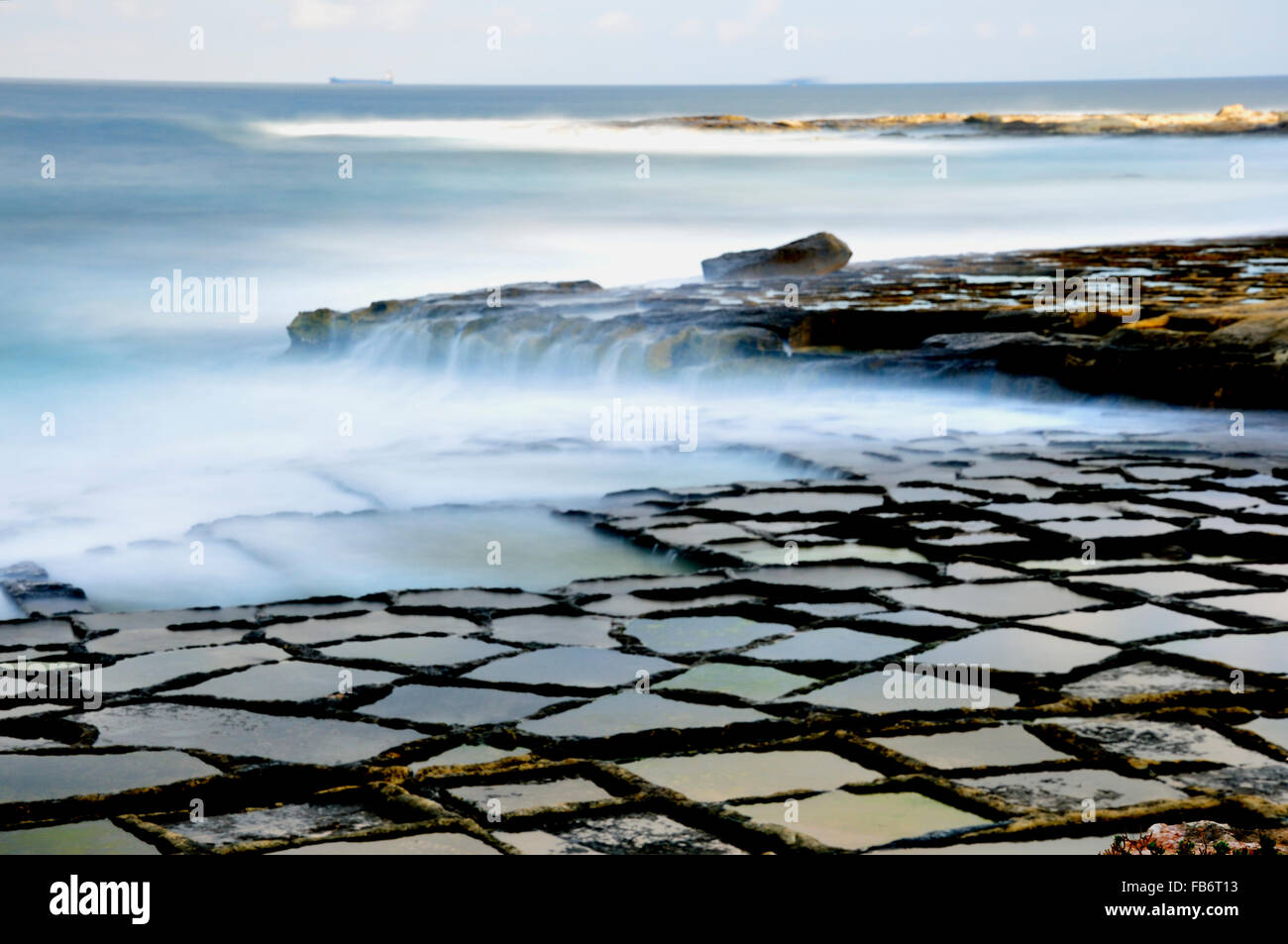 long exposure, early morning coastal view over ancient salt pans ...