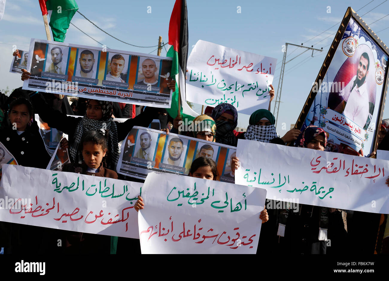 Gaza, Palestine. 11th Jan, 2016. People hold banners and placards as ...