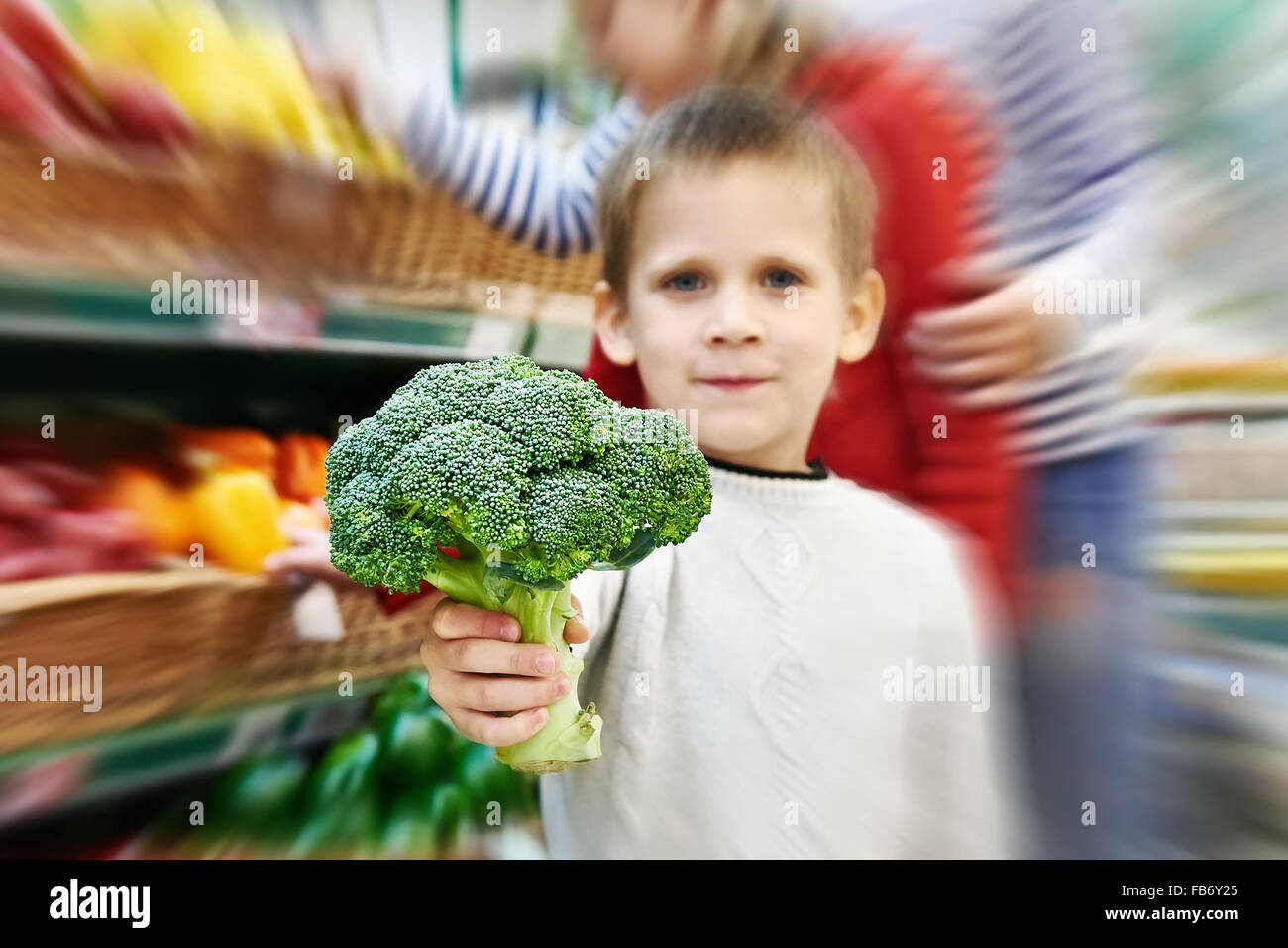 Boy shows broccoli in supermarket Stock Photo - Alamy