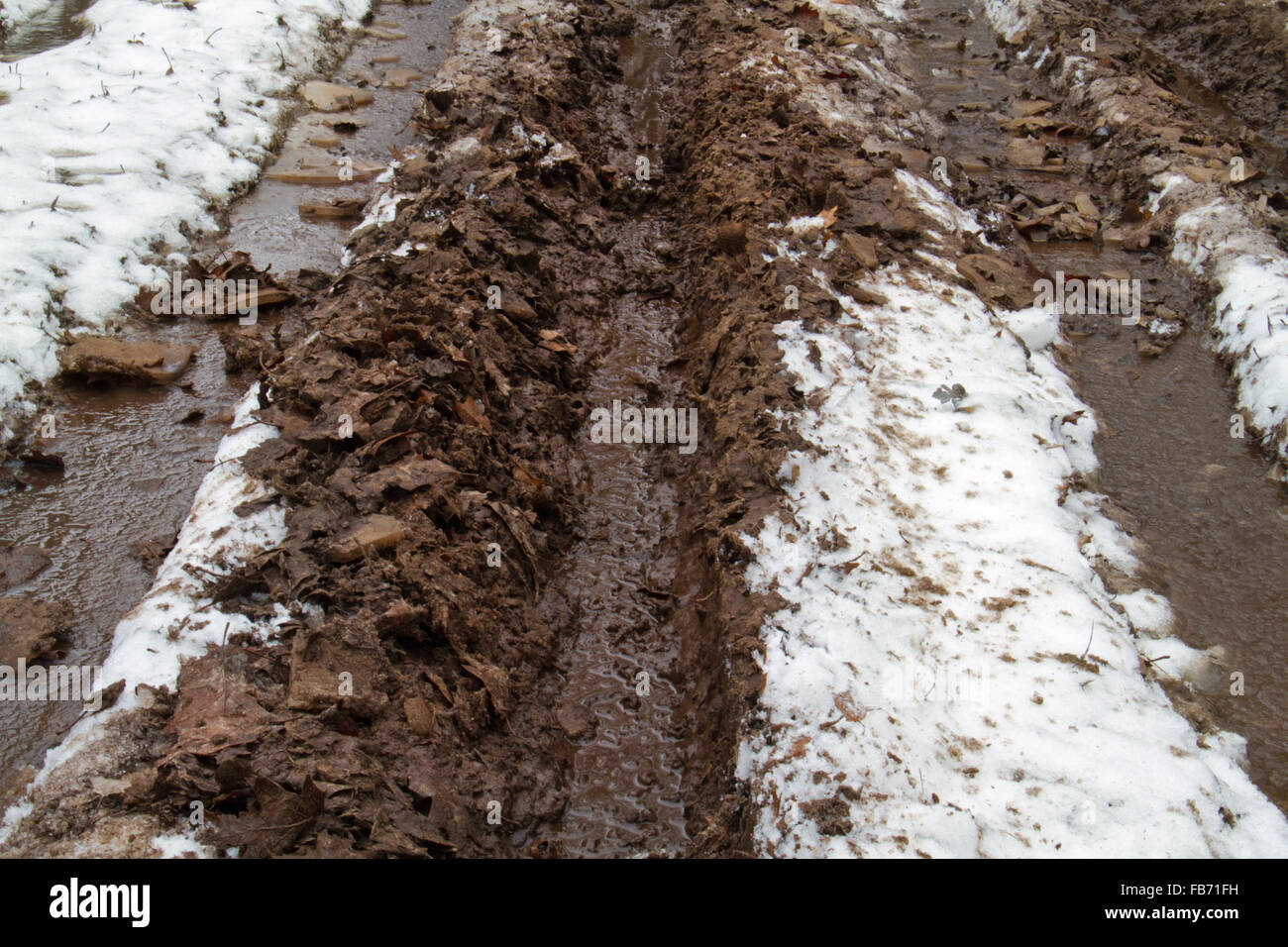 Bad road conditions: snow, ice and mud on a country road Stock Photo ...