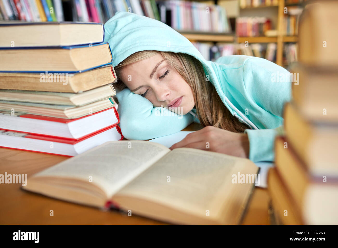 student or woman with books sleeping in library Stock Photo - Alamy