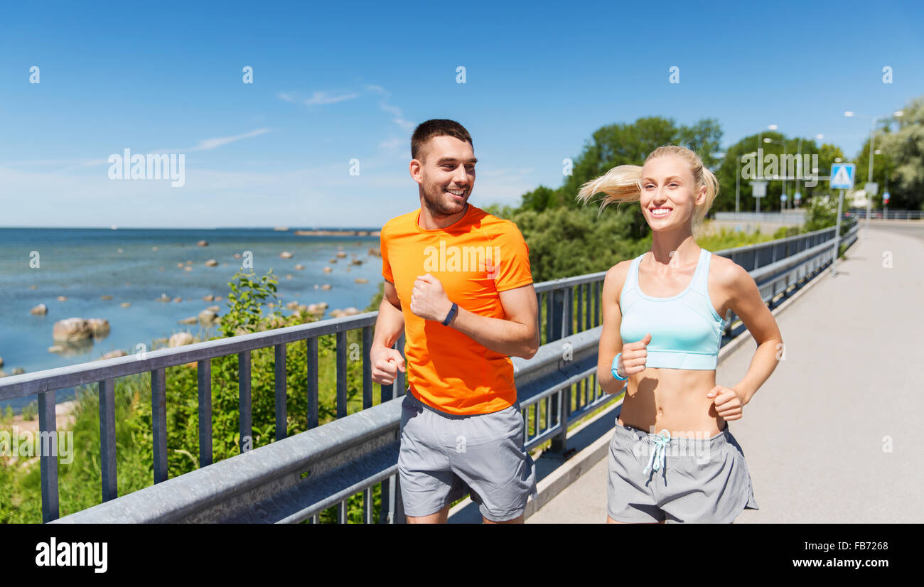 smiling couple running at summer seaside Stock Photo - Alamy