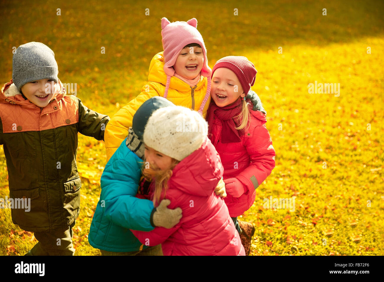 group of happy children hugging in autumn park Stock Photo - Alamy