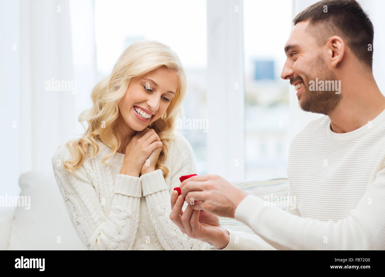 happy man giving engagement ring to woman at home Stock Photo - Alamy