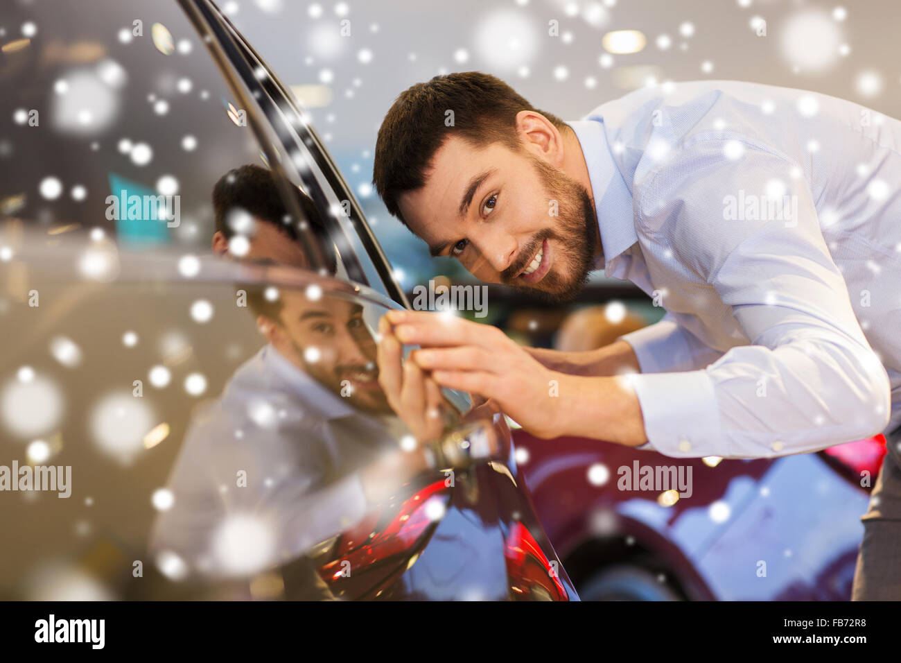 happy man touching car in auto show or salon Stock Photo - Alamy