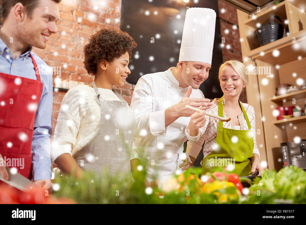happy friends and chef cook cooking in kitchen Stock Photo - Alamy