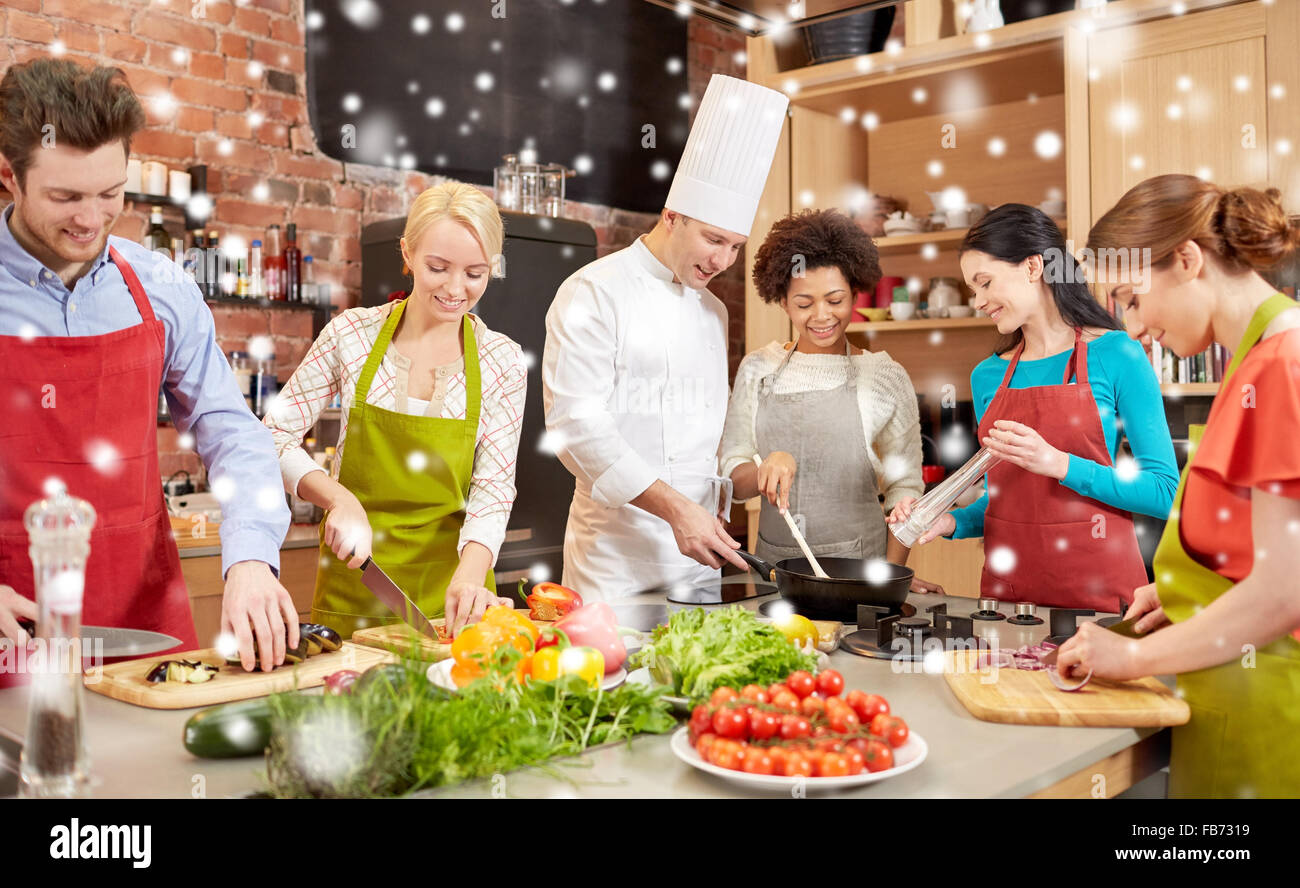 happy friends and chef cook cooking in kitchen Stock Photo - Alamy