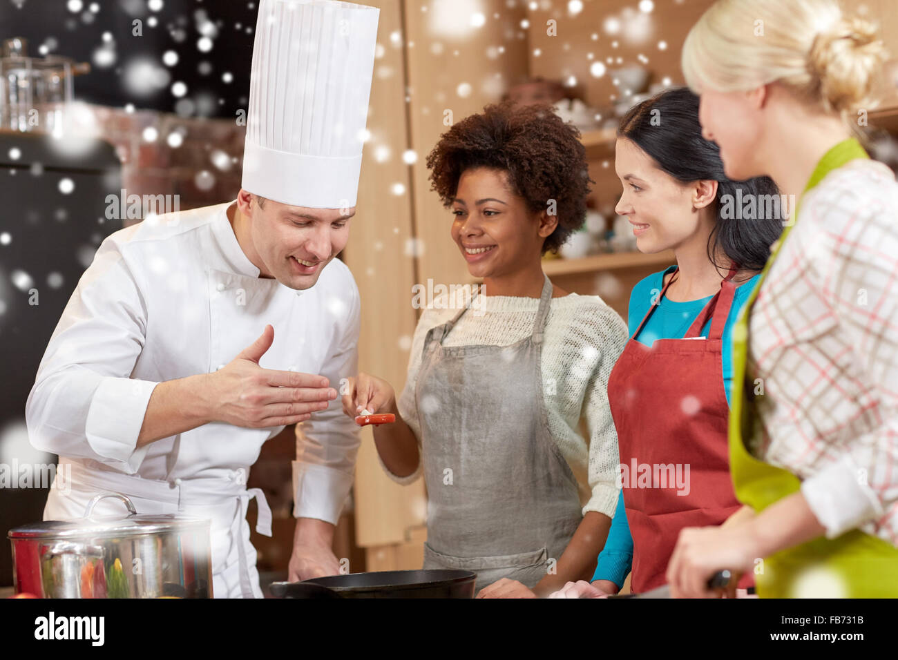 happy women and chef cook cooking in kitchen Stock Photo - Alamy