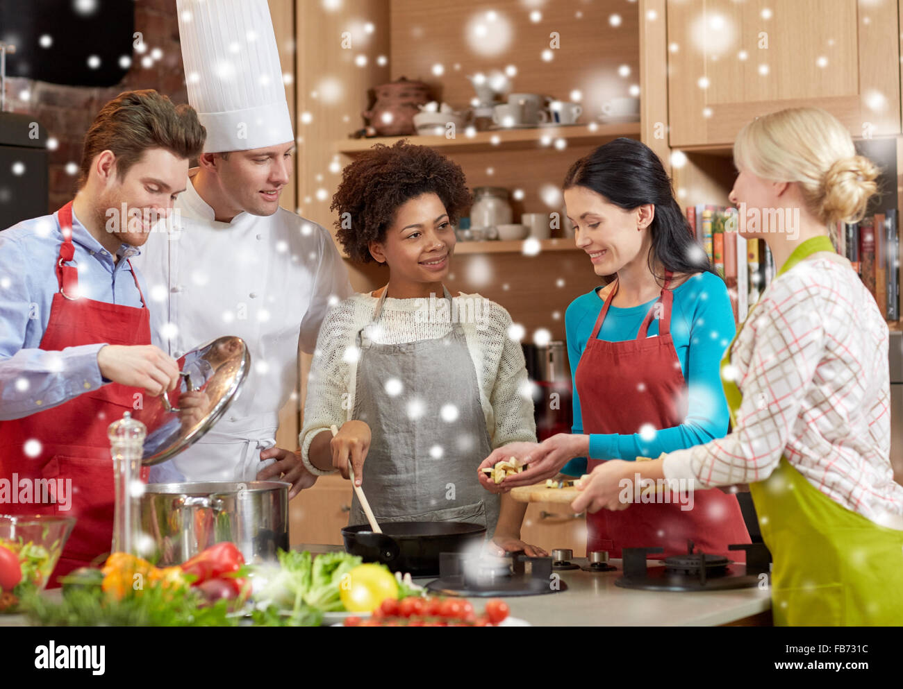 happy friends and chef cook cooking in kitchen Stock Photo - Alamy