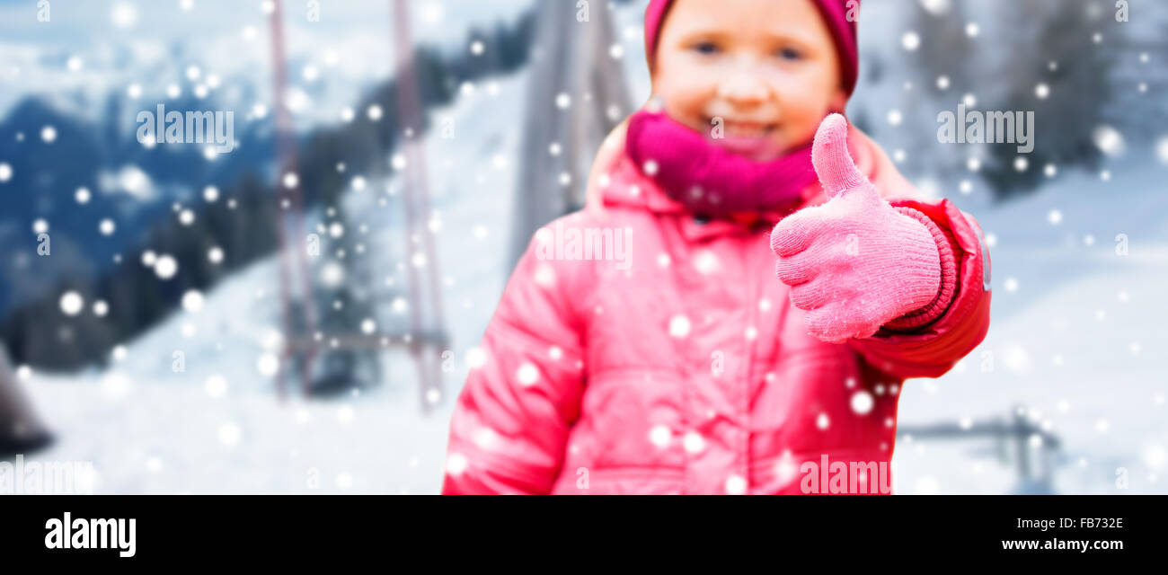 happy girl showing thumbs up over winter Stock Photo - Alamy
