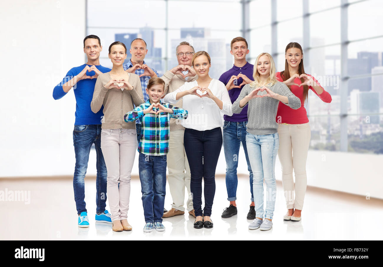 group of smiling people showing heart hand sign Stock Photo - Alamy