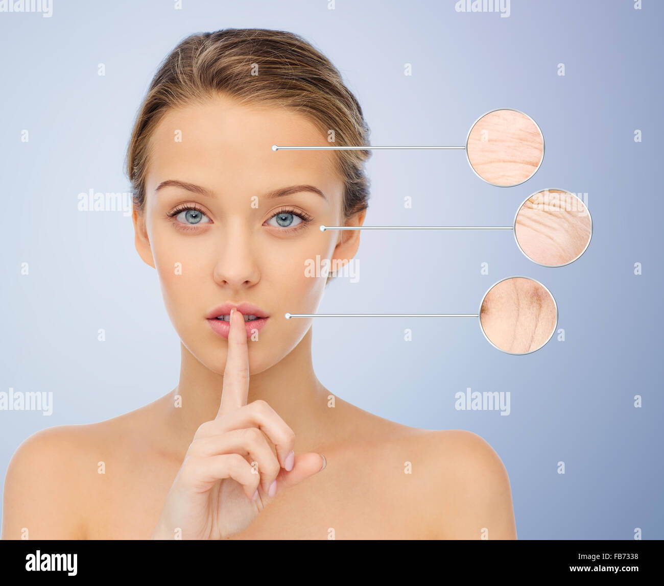 beautiful young woman holding finger on lips Stock Photo - Alamy