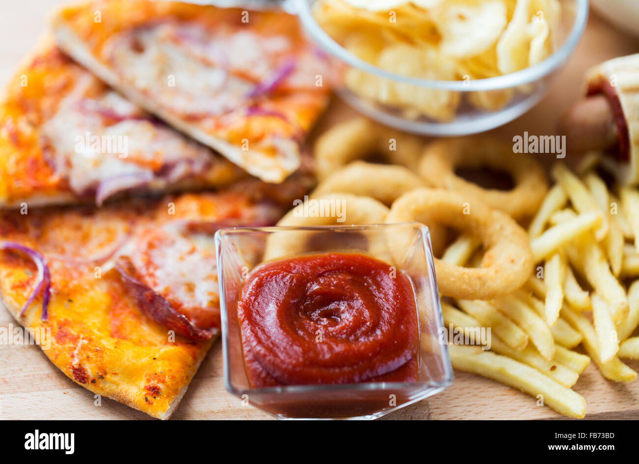 close up of fast food snacks on wooden table Stock Photo - Alamy