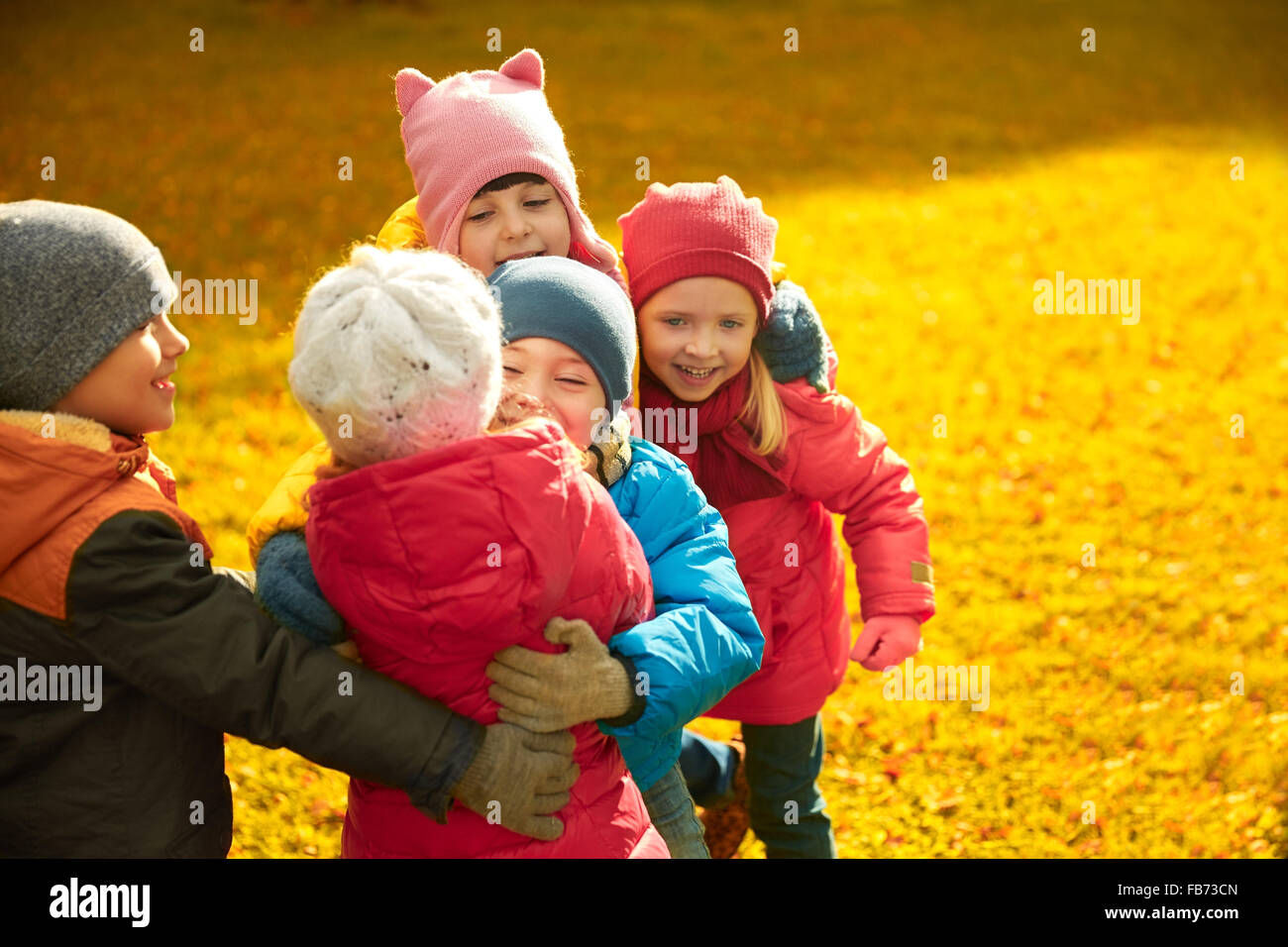 group of happy children hugging in autumn park Stock Photo - Alamy