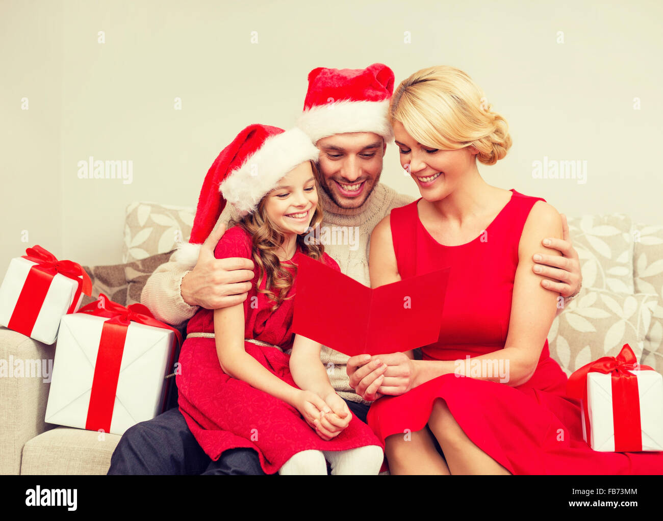 smiling family reading postcard Stock Photo - Alamy