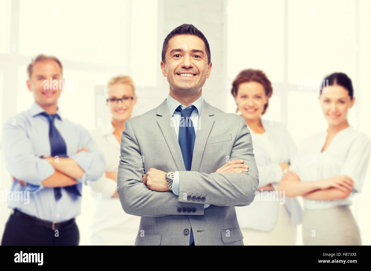 happy smiling business team over office room Stock Photo - Alamy