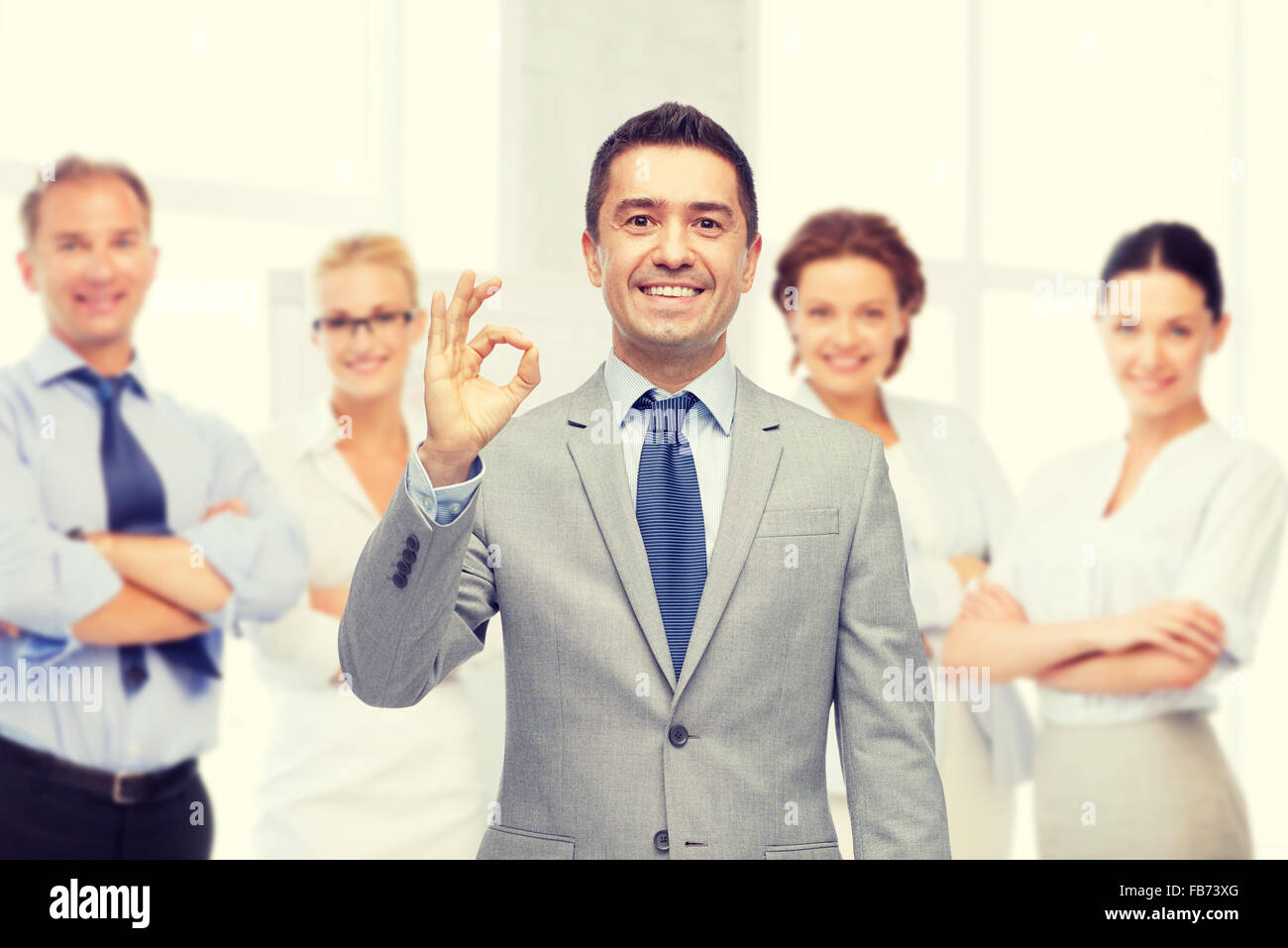happy businessman in suit showing ok hand sign Stock Photo - Alamy
