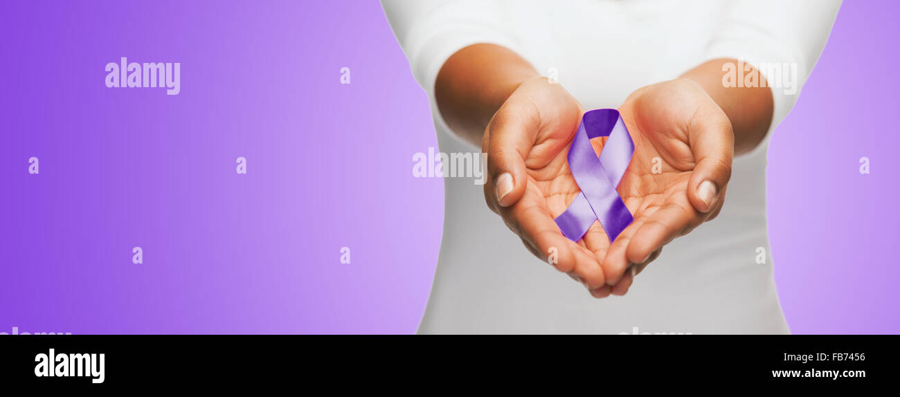 close up of hands holding purple awareness ribbon Stock Photo - Alamy