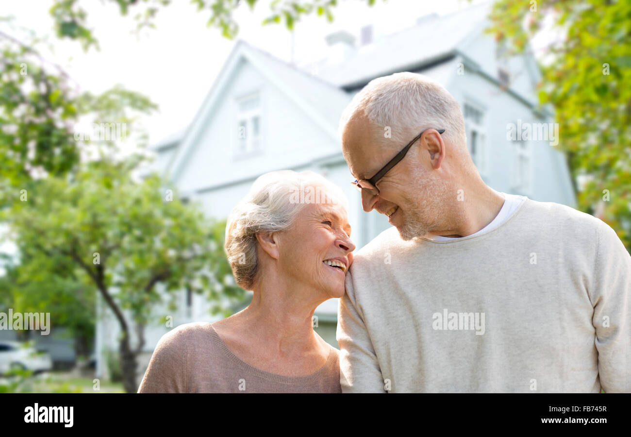 senior couple hugging over living house background Stock Photo - Alamy