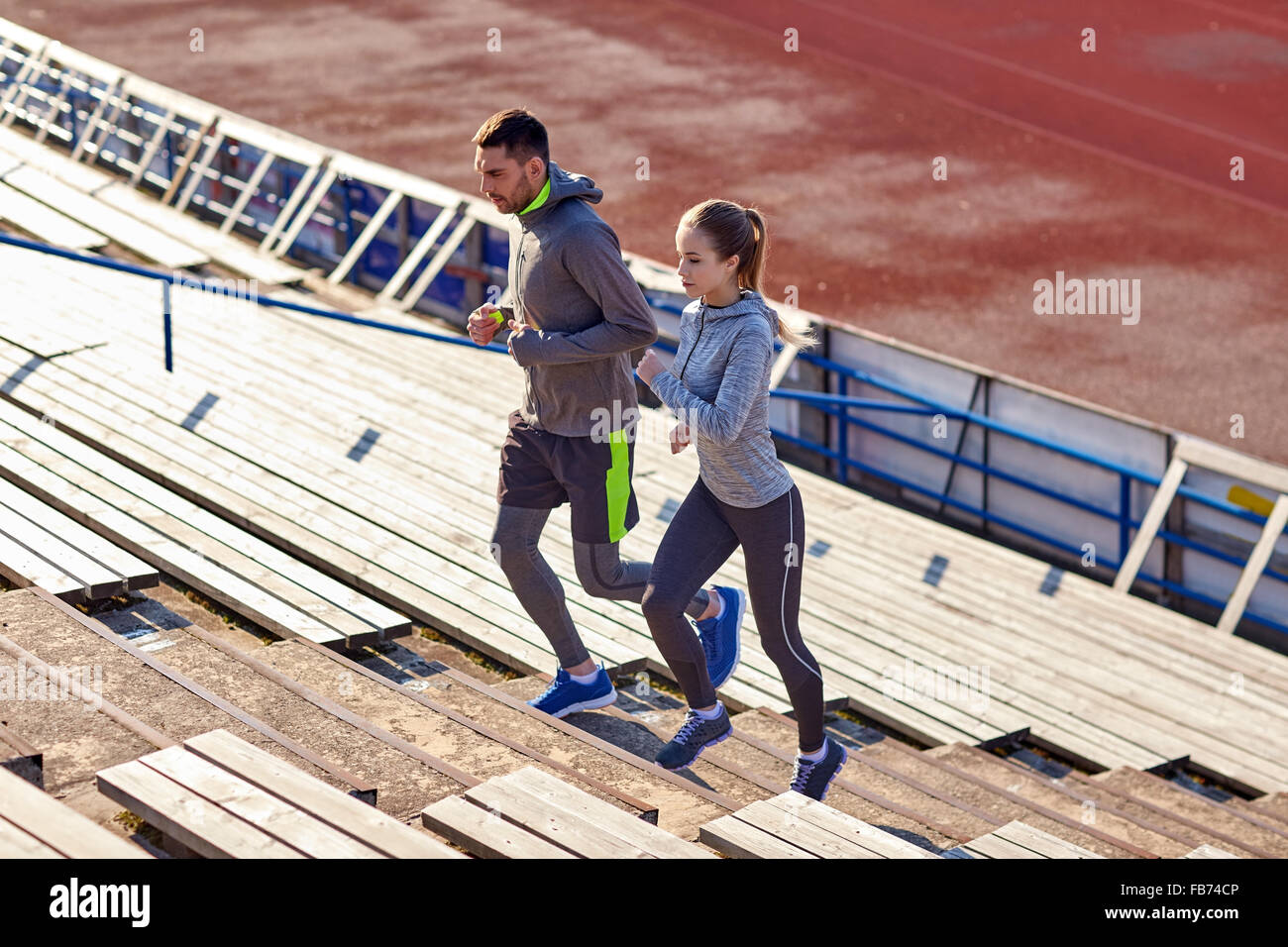 couple running upstairs on stadium Stock Photo - Alamy