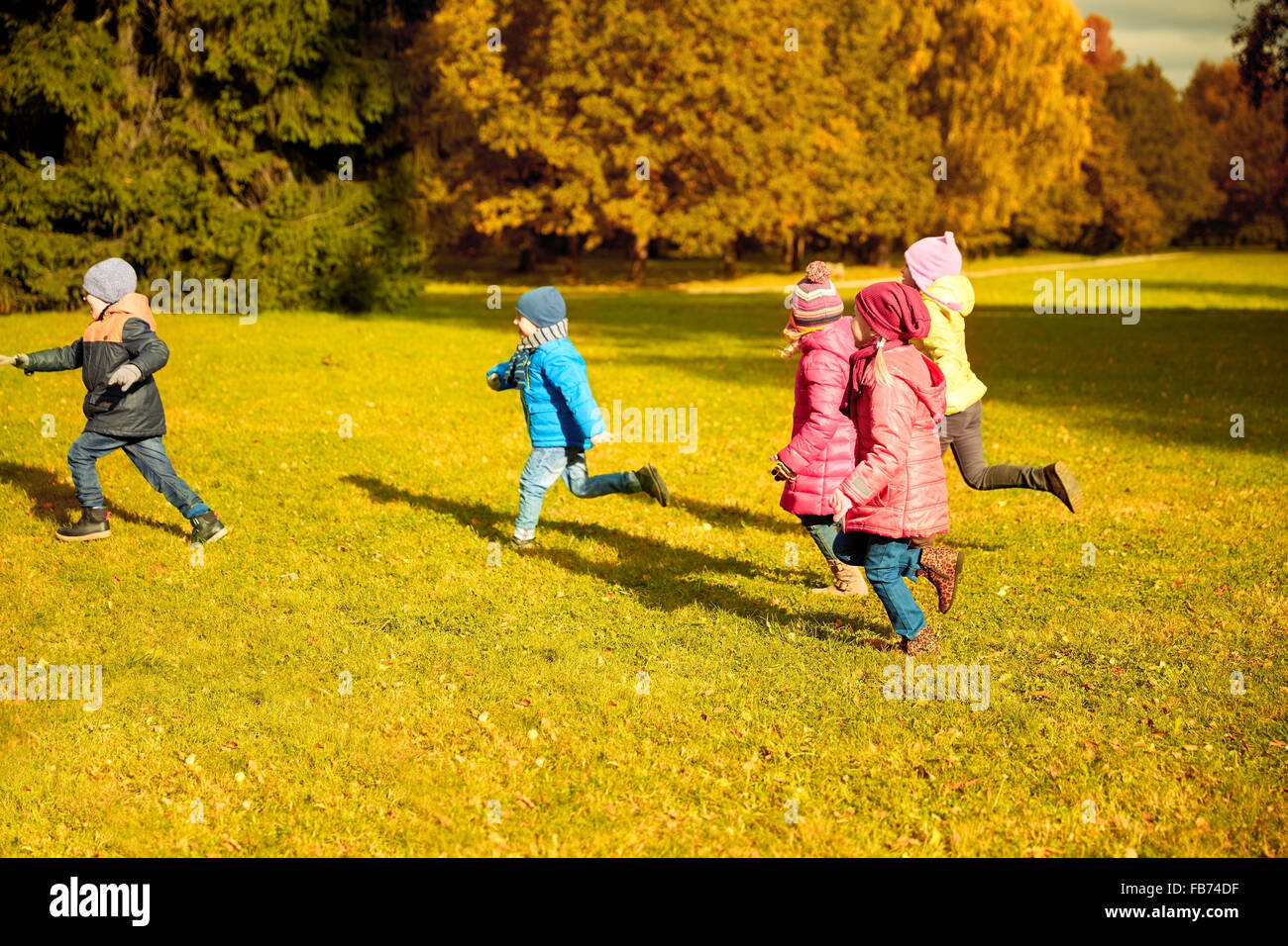 group of happy little kids running outdoors Stock Photo - Alamy