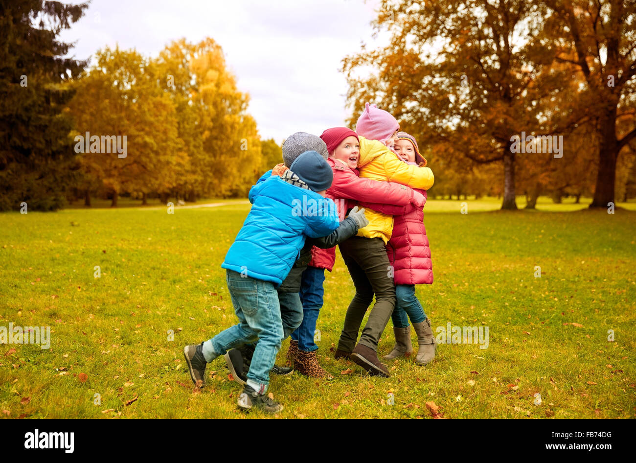 group of happy children hugging in autumn park Stock Photo - Alamy