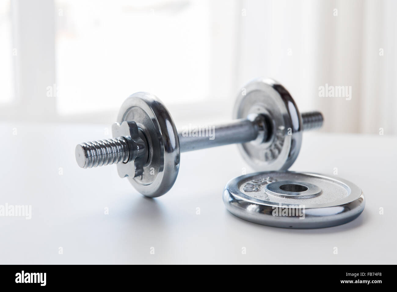 close up of iron dumbbell on table Stock Photo - Alamy
