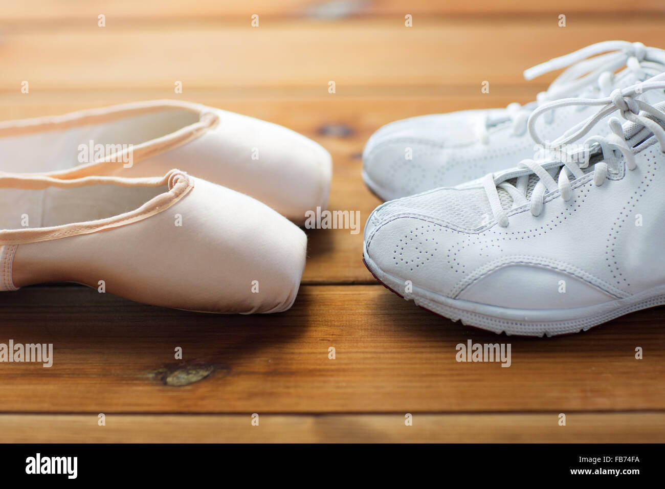 close up of sneakers and pointe shoes on wood Stock Photo - Alamy