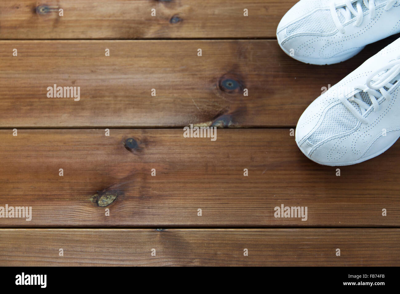 close up of sneakers on wooden floor Stock Photo - Alamy
