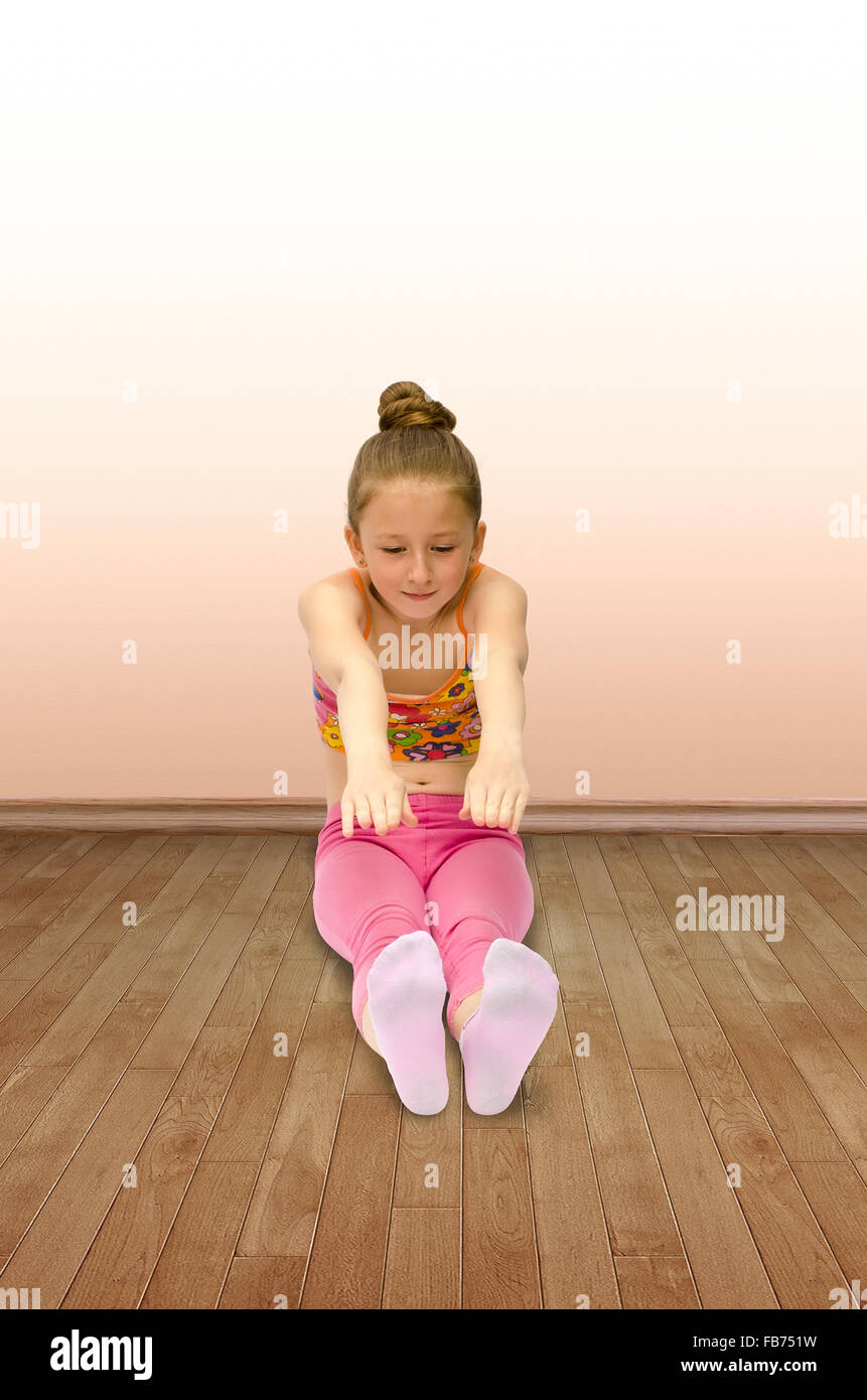 cute little gymnast does exercises Stock Photo - Alamy