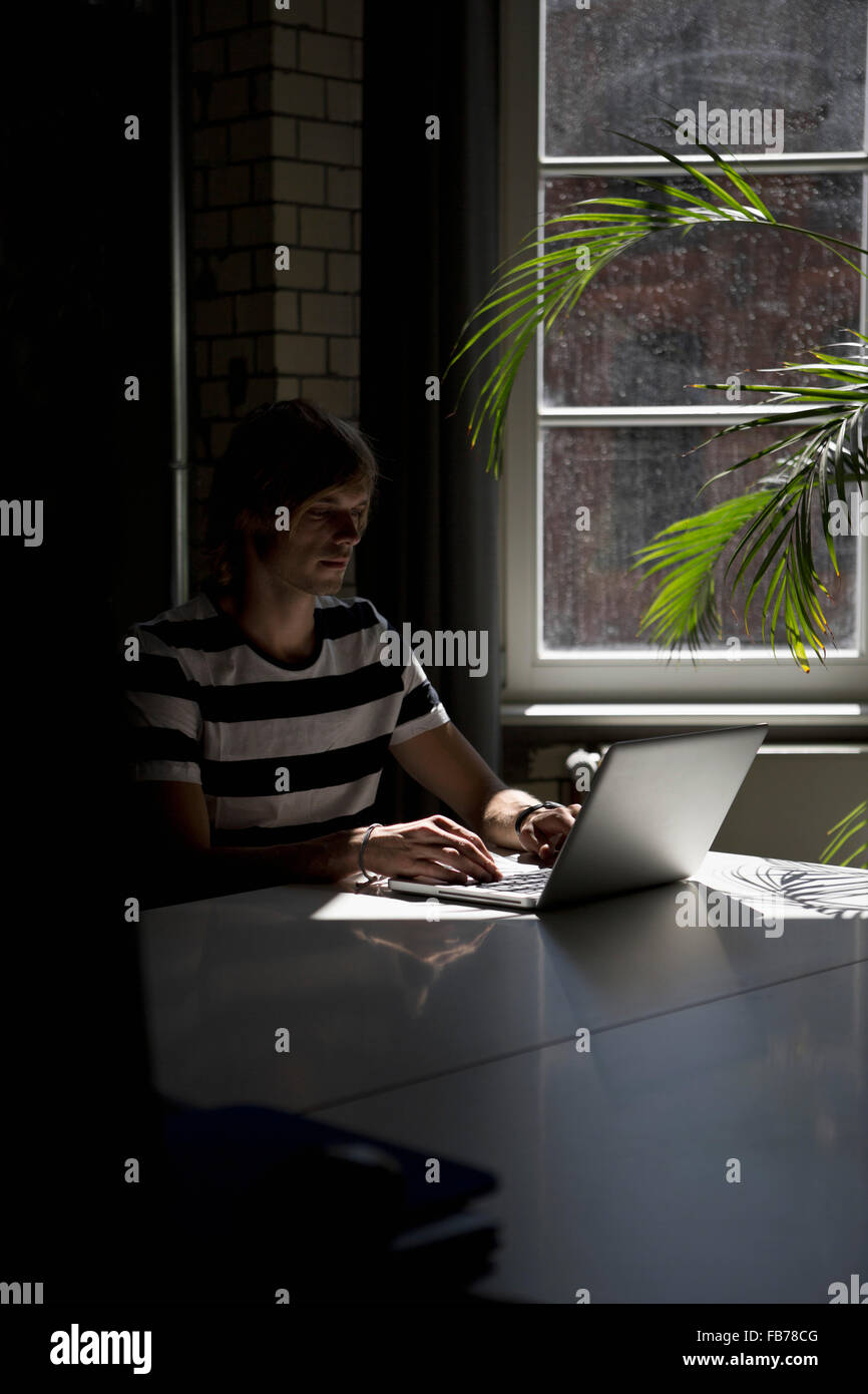 Man using laptop Stock Photo - Alamy