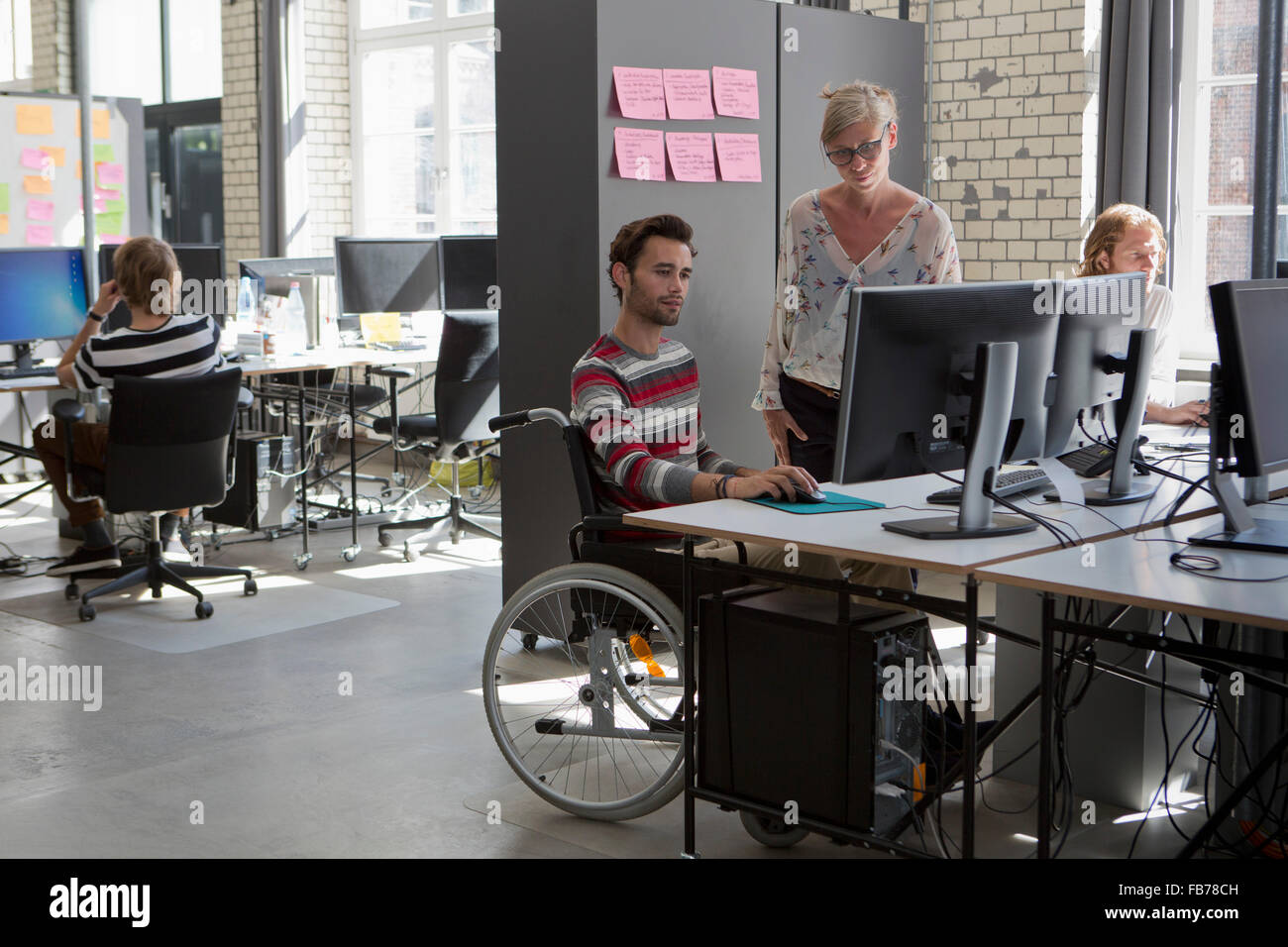 Man and woman working on computer in office Stock Photo - Alamy