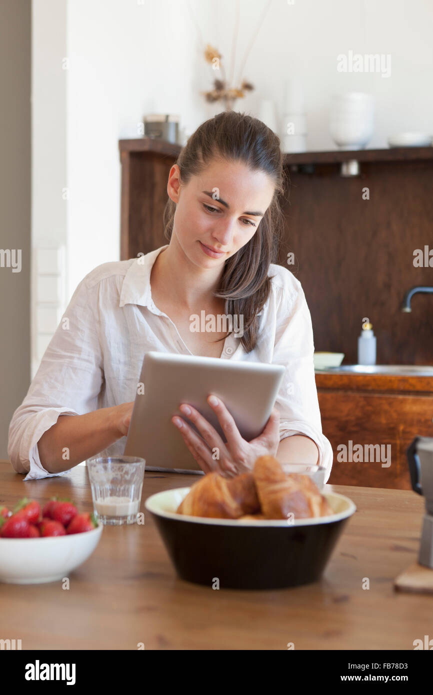 Young woman sitting dining table hi-res stock photography and images ...