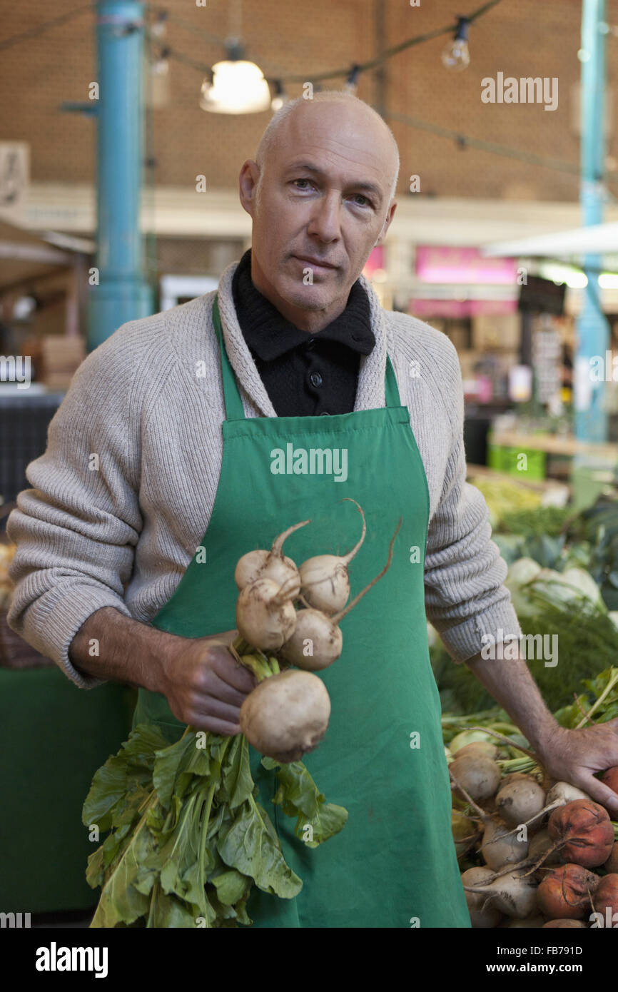 Mature man holding turnip, portrait Stock Photo - Alamy