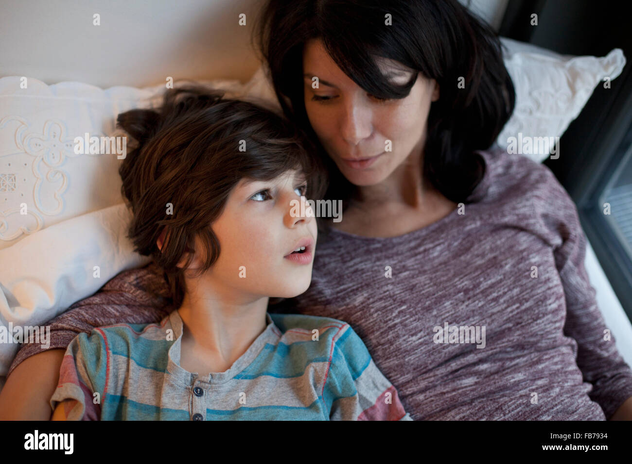 Mother and son lying on bed Stock Photo - Alamy