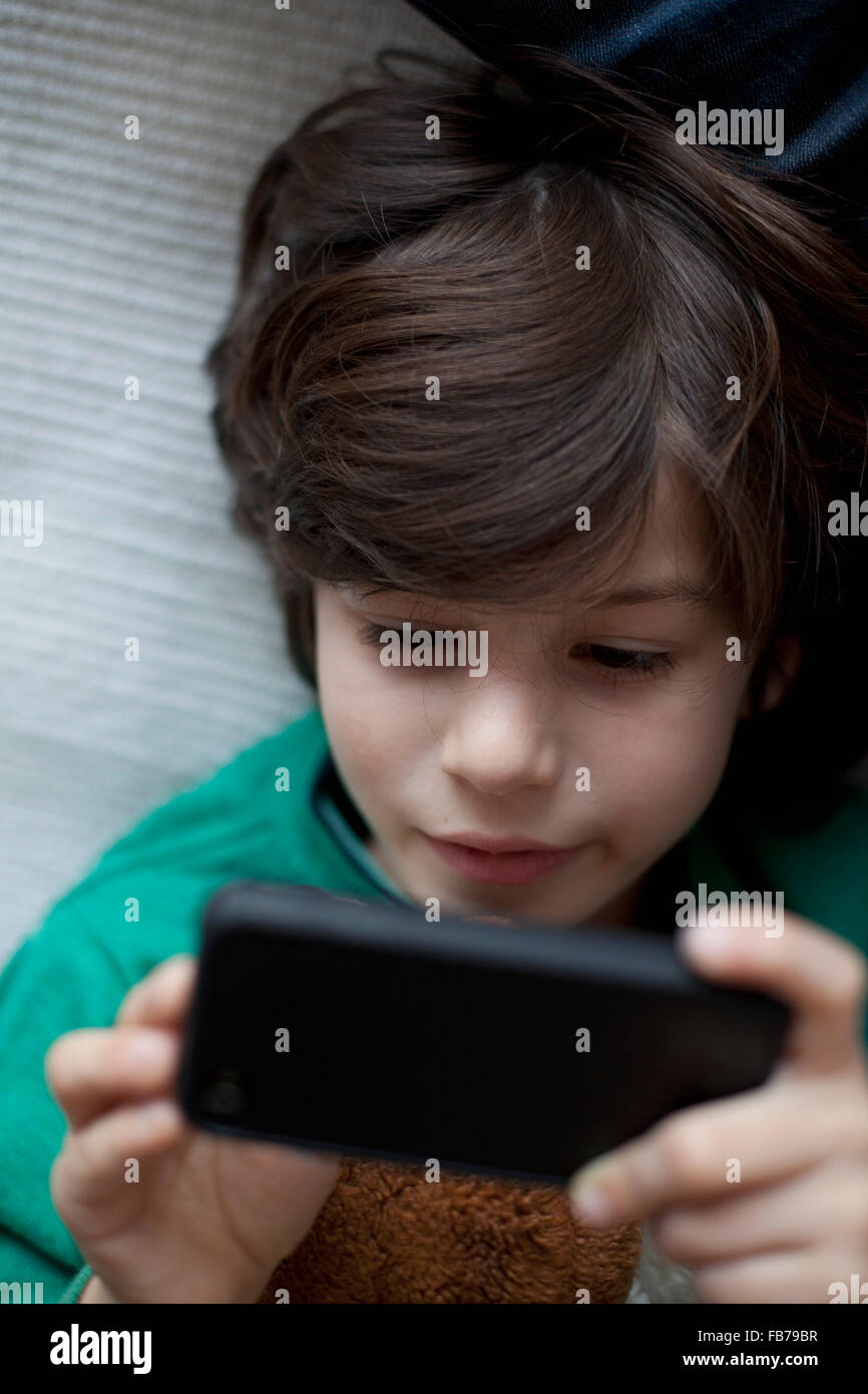 Boy playing with mobile phone Stock Photo - Alamy