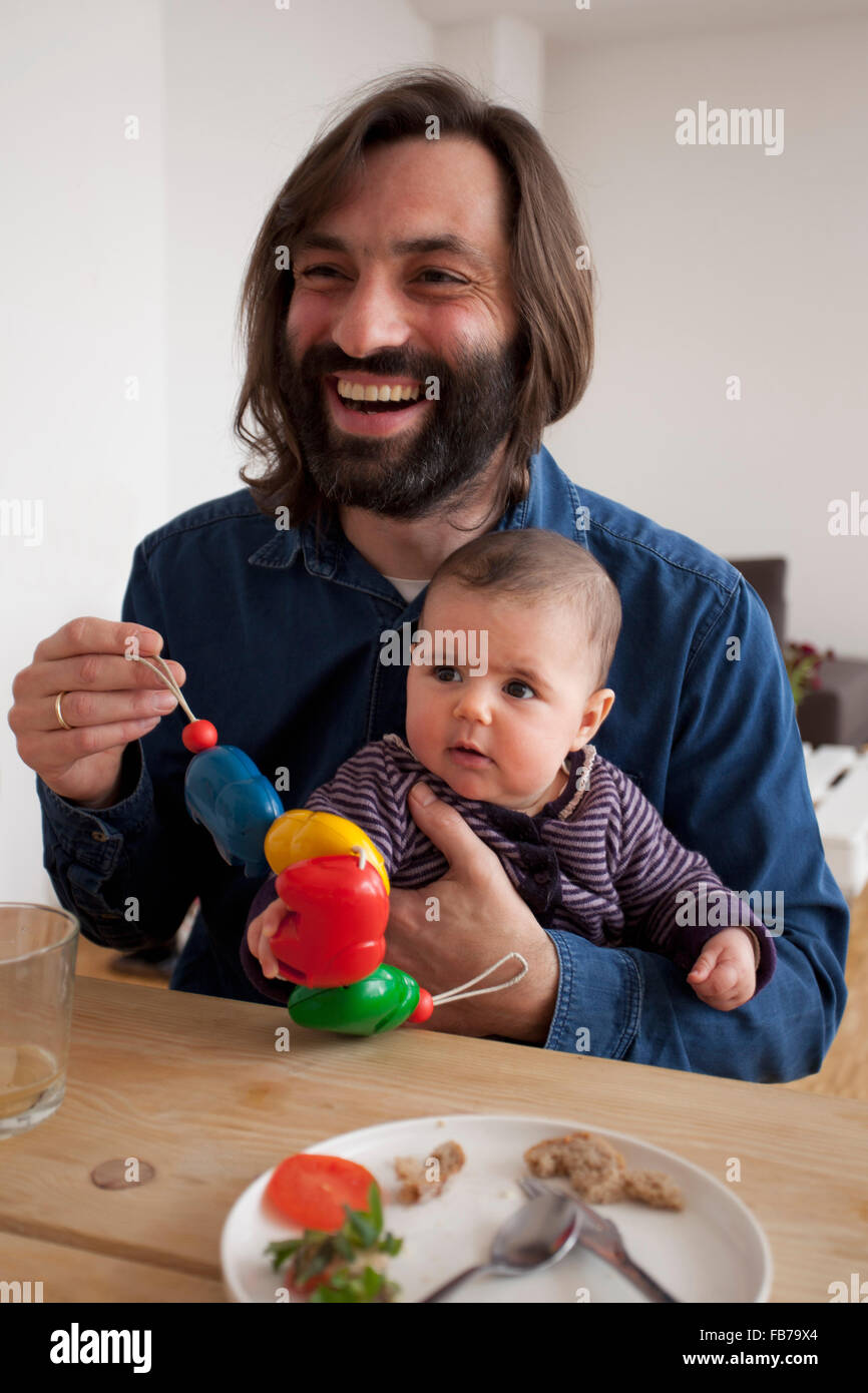 Happy family sitting table hi-res stock photography and images - Alamy