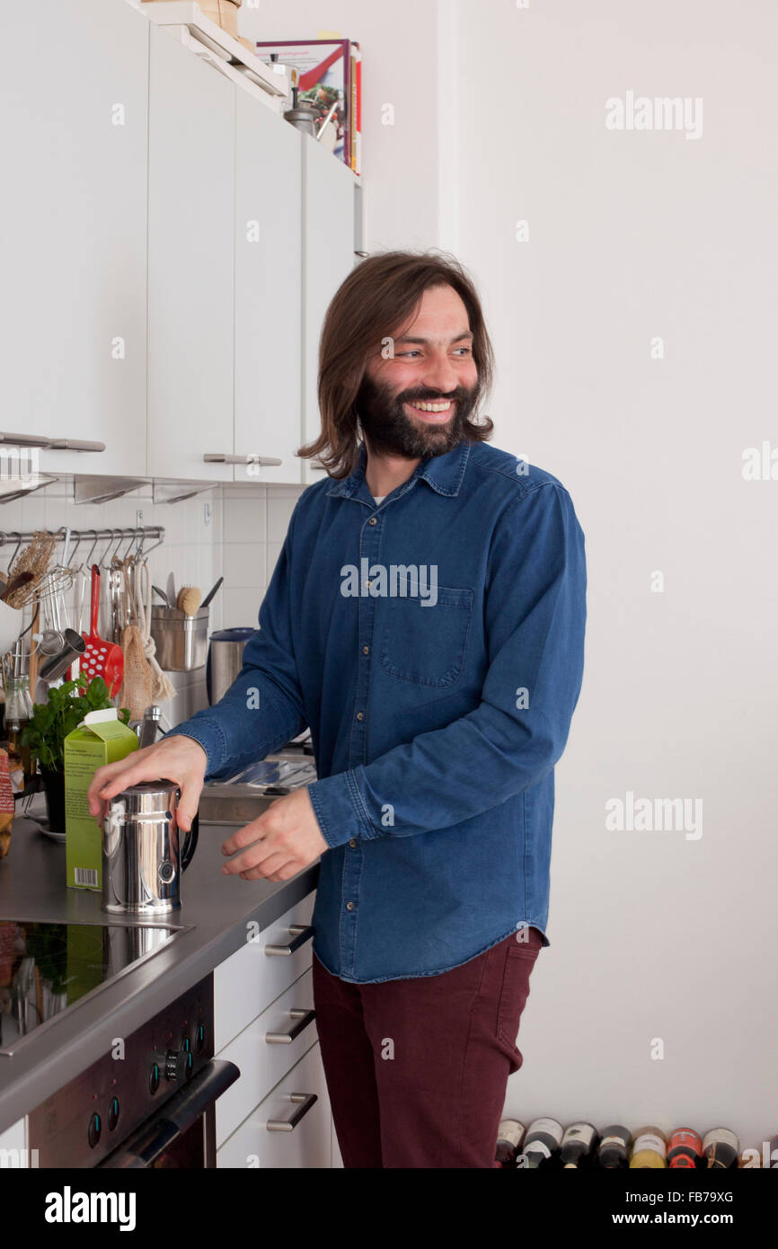 Man standing cabinet home cabinet hi-res stock photography and images ...