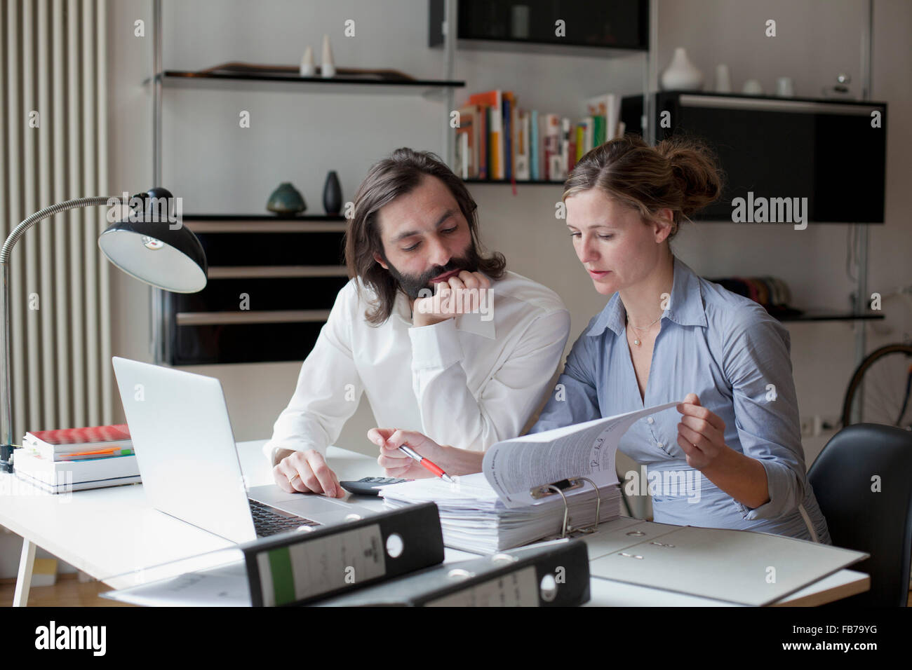Mid adult couple working at home Stock Photo - Alamy