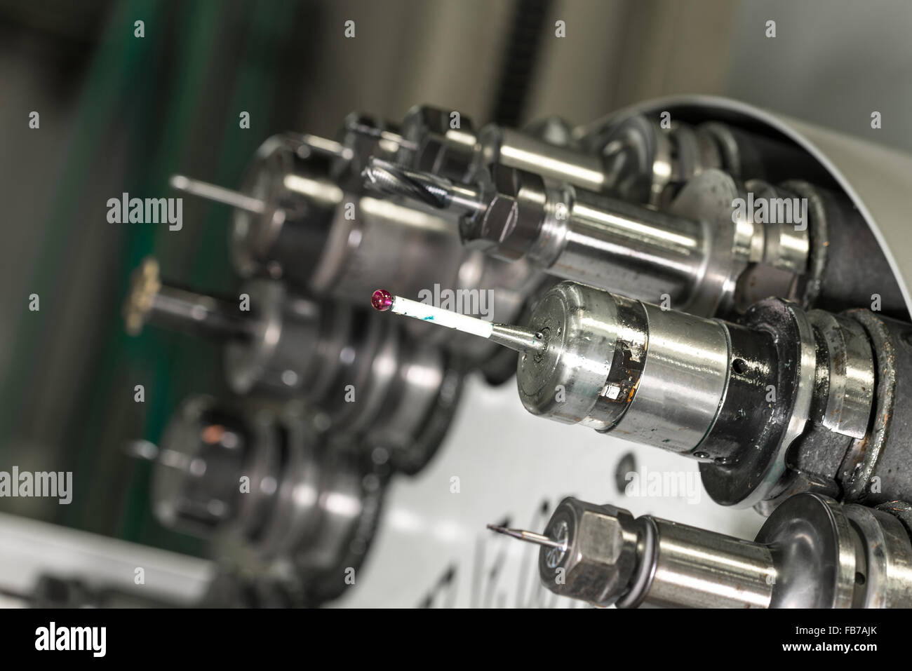 Rotating head with drilling machine bits and tools in a high precision mechanics plant at CNC ...