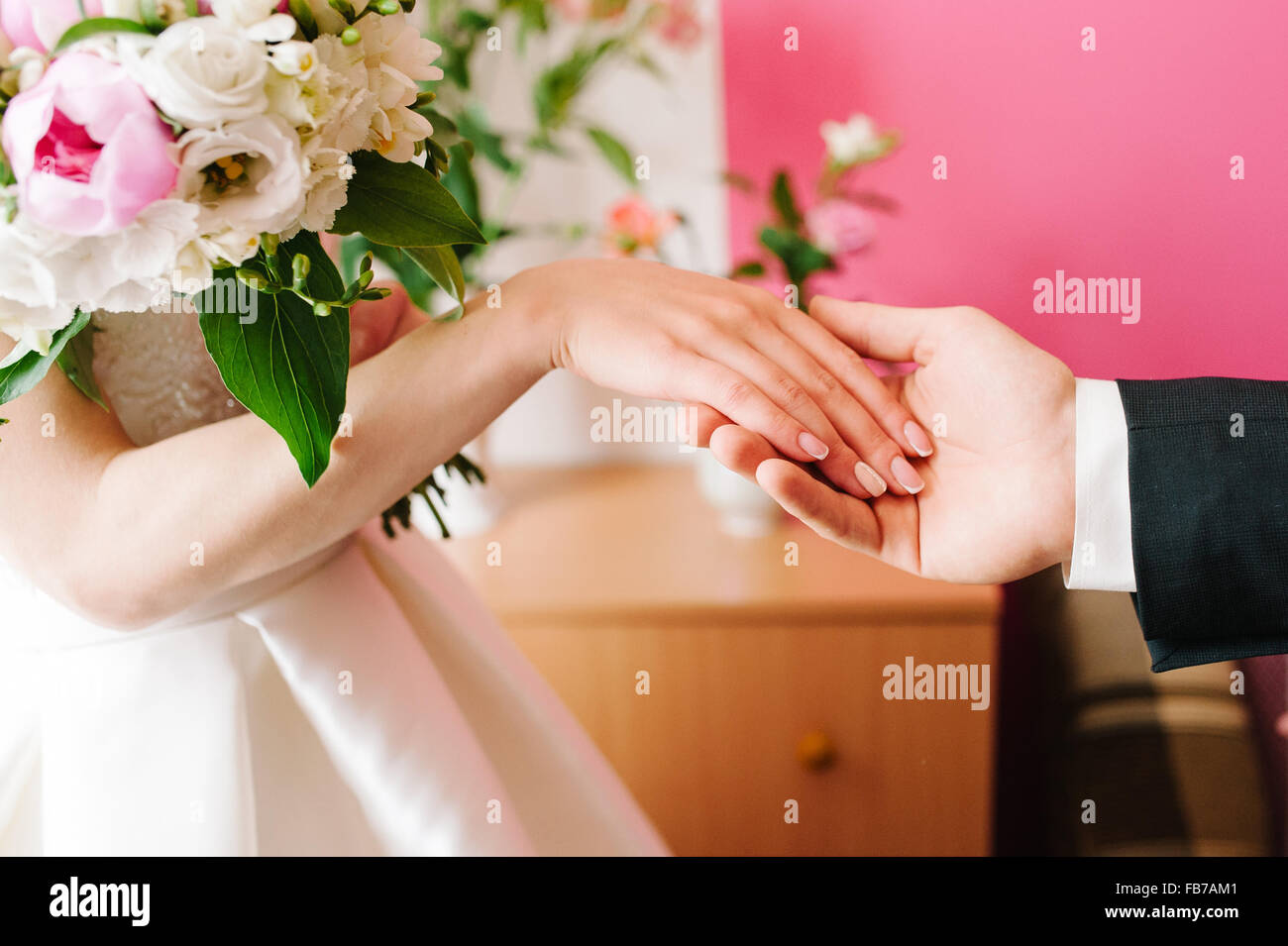 Bride and groom holding hands Stock Photo - Alamy