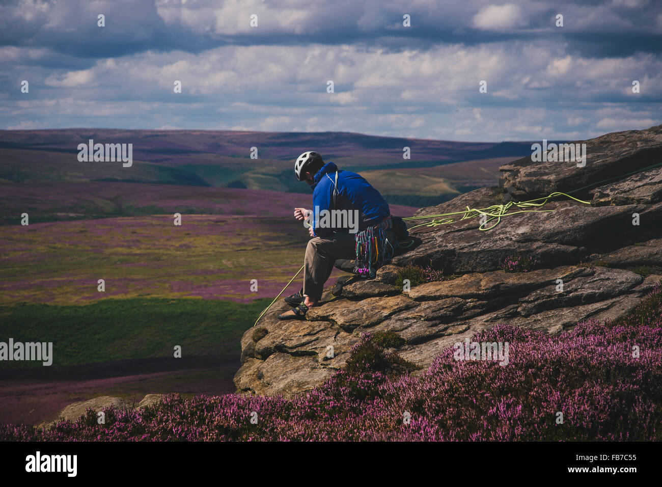 Person sitting on rock hi-res stock photography and images - Alamy