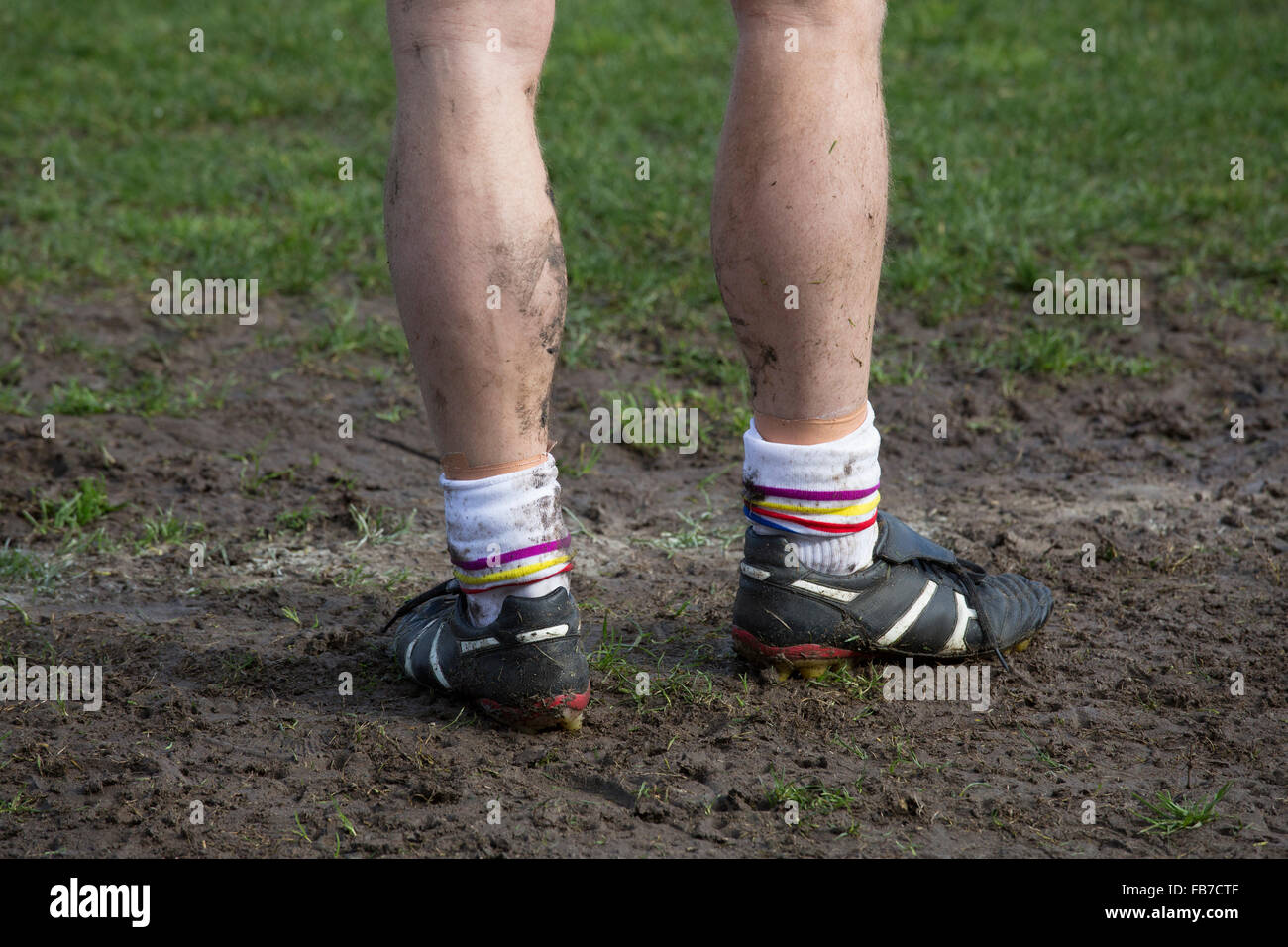 Low section of man with messy legs standing on field Stock Photo - Alamy