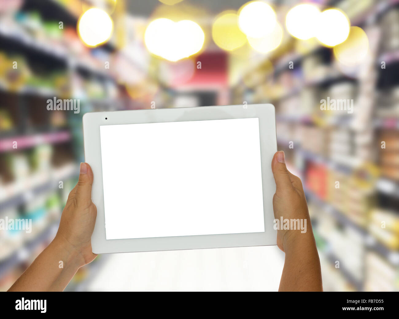hand holding tablet in supermarket Stock Photo - Alamy