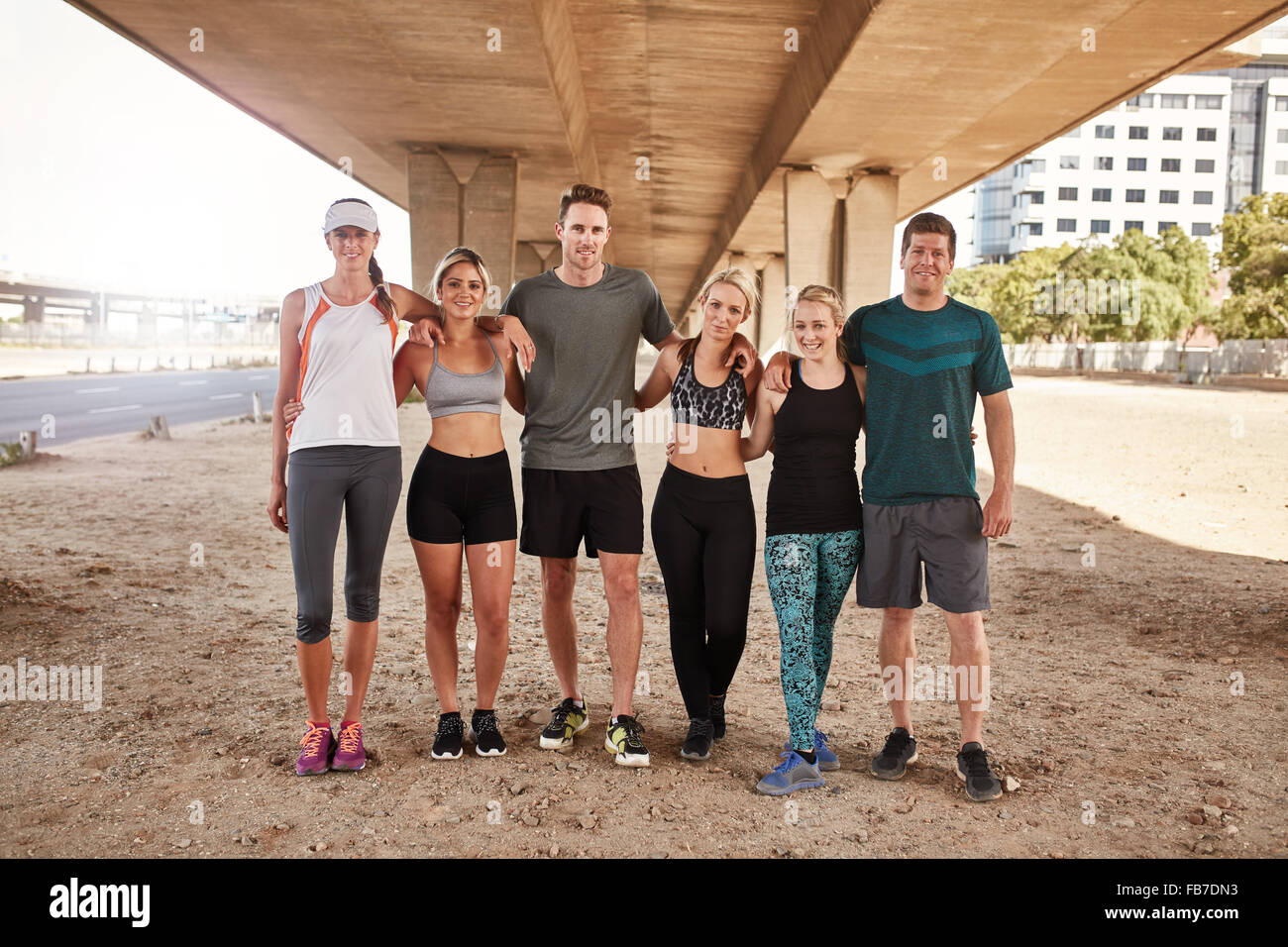Portrait of running club group standing together and posing for camera ...