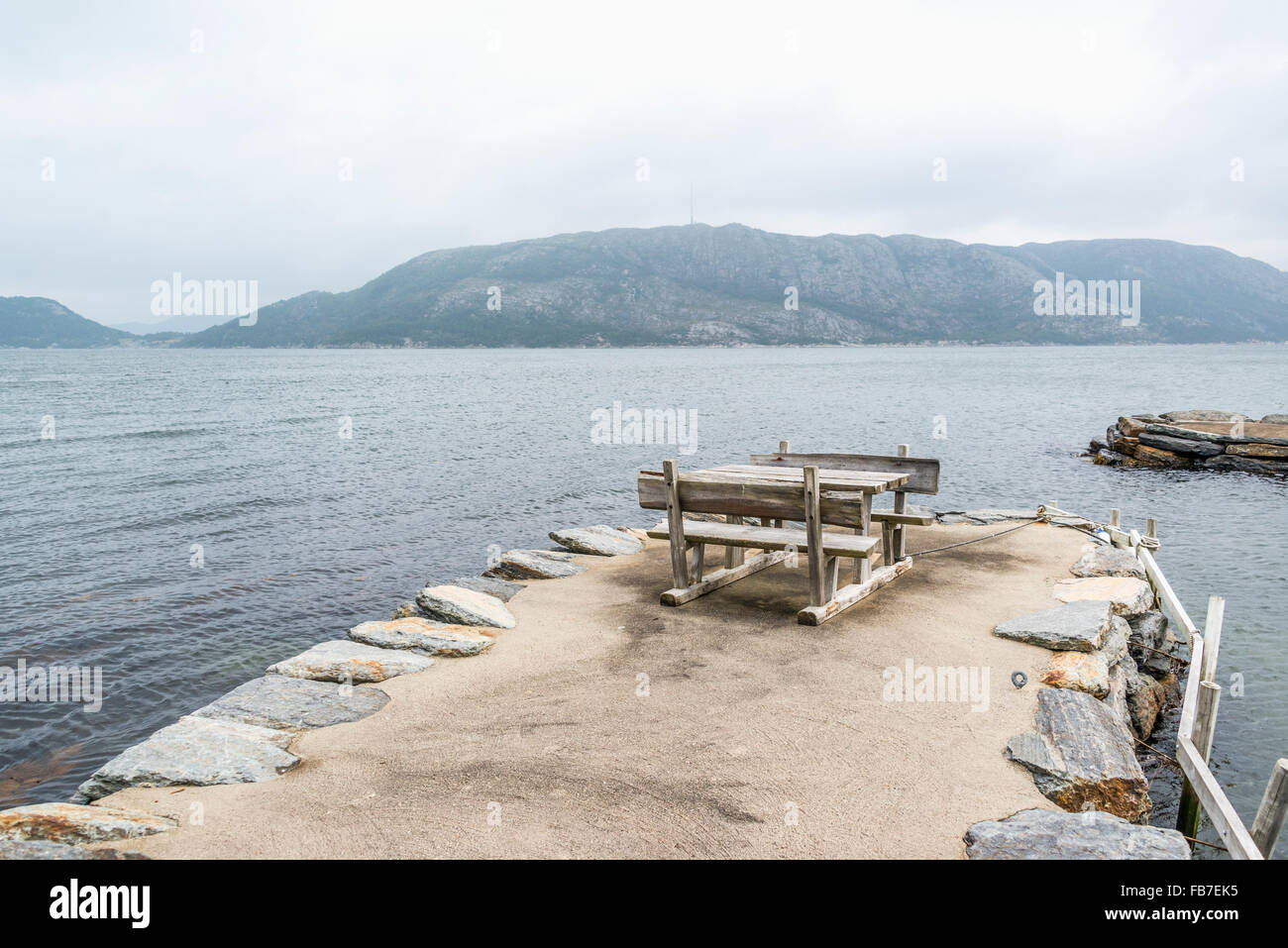 Picnic table on pier over lake Stock Photo - Alamy