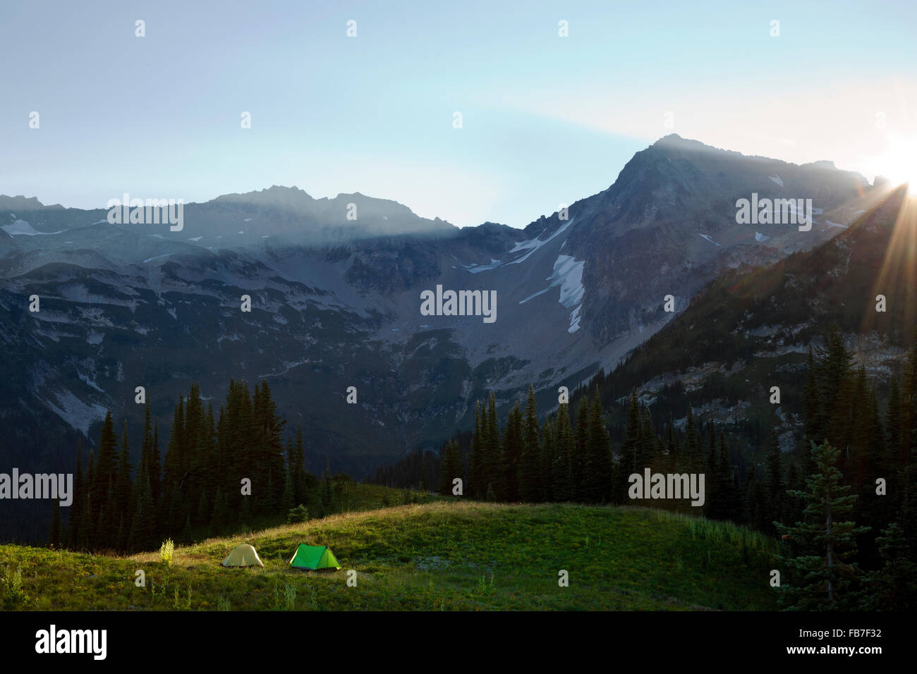 WASHINGTON - Sun rising over Helmet Butte and hitting the tents camped ...