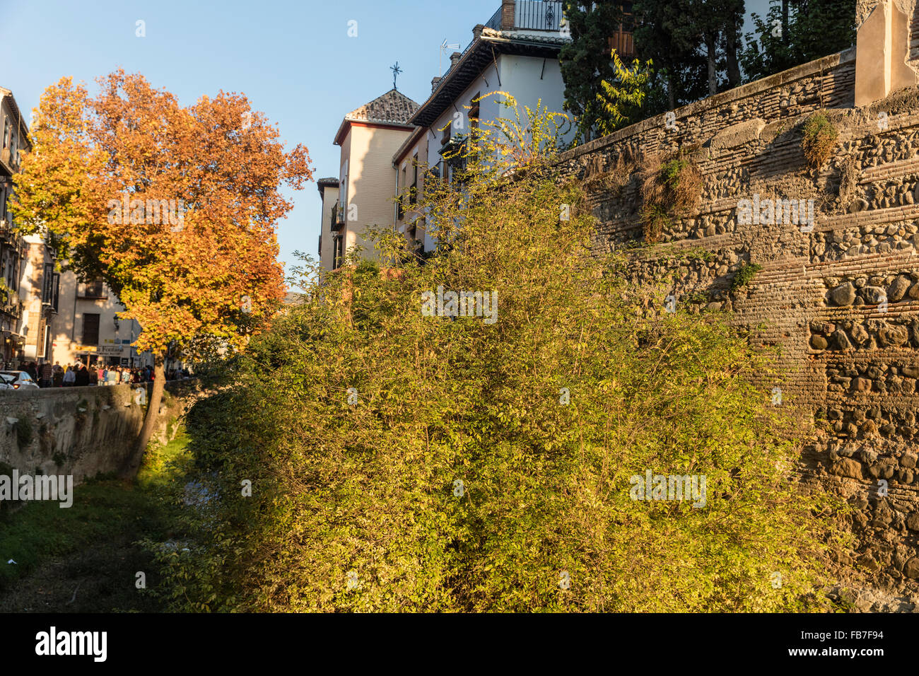 River Darro in Granada at the foot of the Alhambra Palace with autumn ...