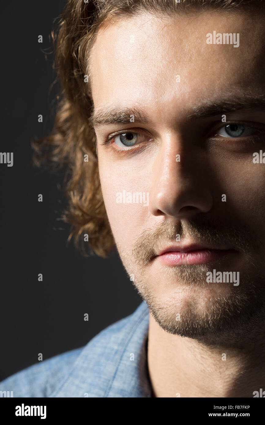 Close-up portrait of serious man against black background Stock Photo ...